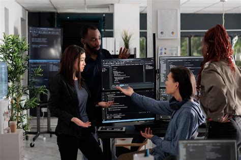 Premium Photo Multi Ethnic Web Developers Writing Script While Talking About Develop Cloud