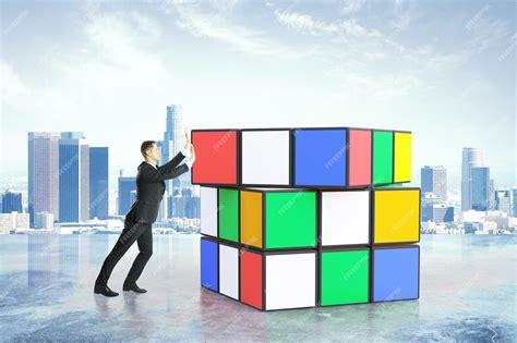 Premium Photo Businessman Solving Rubiks Cube On City Background