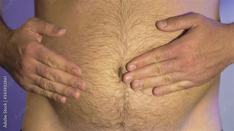 Man Slaps His Hands Against His Hairy Fat Belly And Waves Of