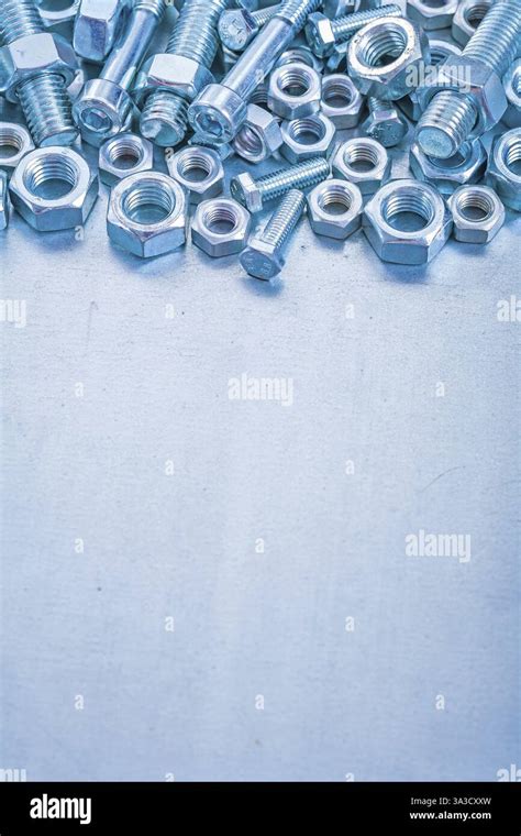Stack Of Metal Bolt Details And Screw Nuts On Metallic Background