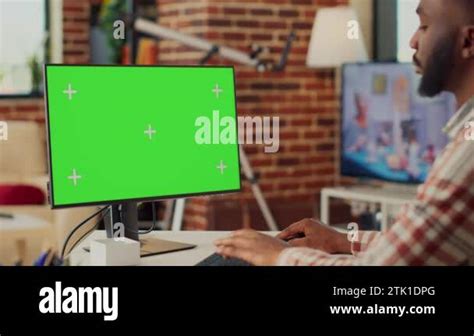 Buisnessman Analyzing Greenscreen Display On Monitor Looking At Isolated Template On Pc And