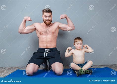 Cheerful Father And His Little Son Showing Biceps Stock Image Image