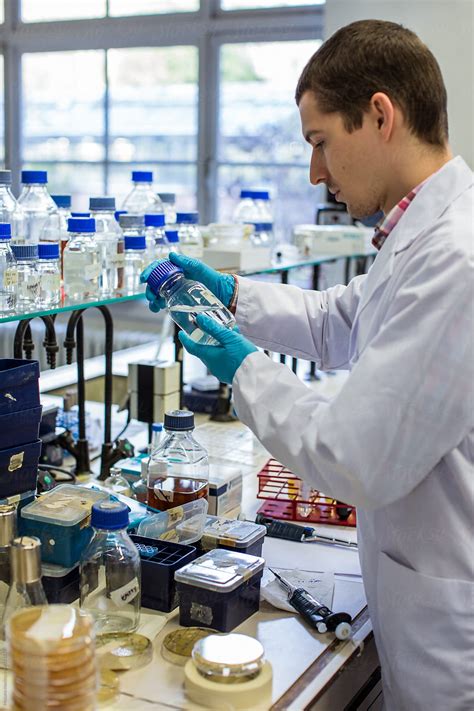 Man Organizing Samples In A Chemistry Lab By Stocksy Contributor
