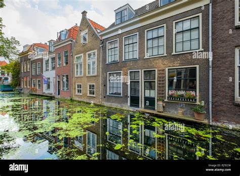 Old Canal Houses With Beautiful Reflections In The Water In The Centre
