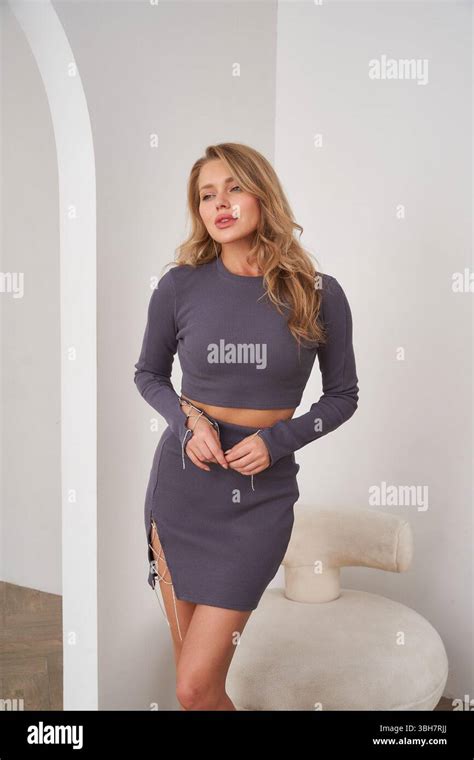 Young Woman With Long Blonde Hair In A Minimalist Indoors Setting