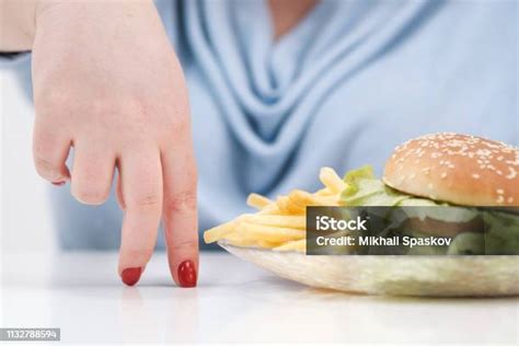 흰색 바탕에 캐주얼 블루 옷에 젊은 무성 한 뚱뚱한 여자의 손가락 건강 한 음식과 패스트 푸드 개념 사이의 선택 다이어트와 적절 한 영양 가냘픈에 대한 스톡 사진 및 기타