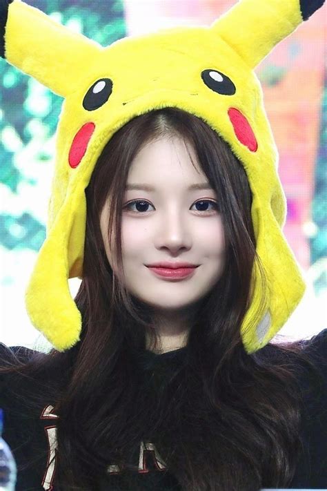 A Woman With Long Hair Wearing A Pikachu Hat