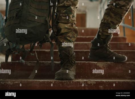 Military Mission Soldier In Uniform On Stairs Inside Abandoned