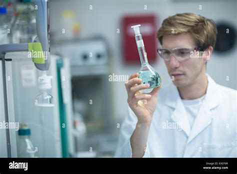 Male Scientist Looking At Flask In Lab Stock Photo Alamy