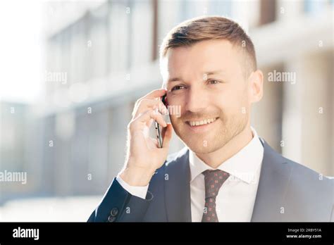 Confident Happy Middle Aged Businessman Communicates Via Cell Phone
