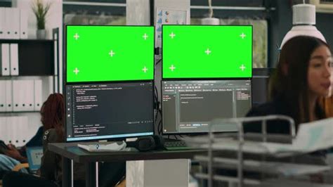 Database Developer Analyzing Greenscreen Display On Multiple Screens