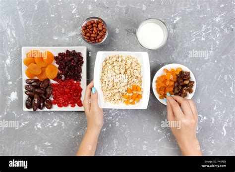 The Girl Is Preparing Her Muesli For Breakfast The Girl Puts Herself A