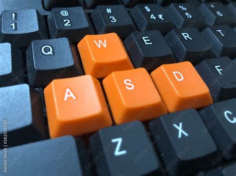 image of orange colored gaming keys wasd on a classic gaming keyboard