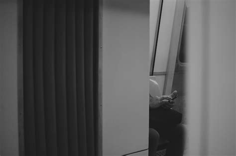premium photo person sitting by window at home