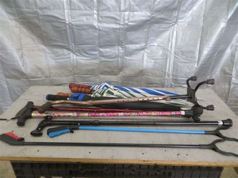four umbrellas four canes two picker uppers lambrecht auction inc