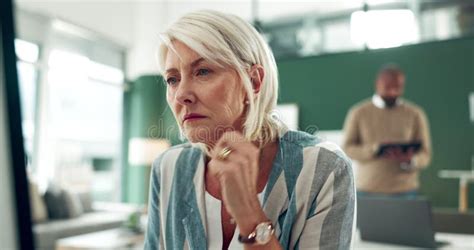 Executive Mature Woman And Thinking By Computer With Problem Solving