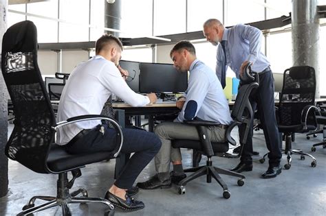 Premium Photo Group Of Modern Business Men In Formalwear Analyzing Stock Market Data While