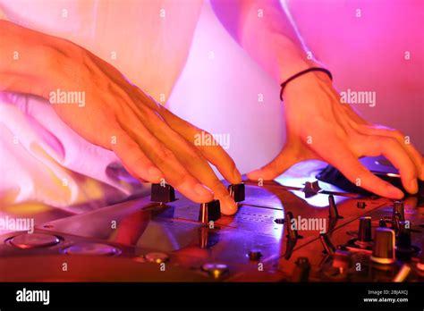 DJ Mixing Tracks On A Mixer In A Nightclub Stock Photo Alamy