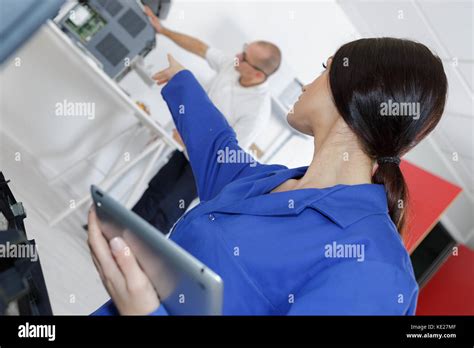 Woman Pointing And Giving Instructions To Senior Colleague Stock Photo Alamy