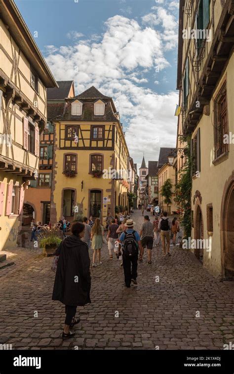 People On Street In Medieval Village Of Riquewihr Alsace France Stock