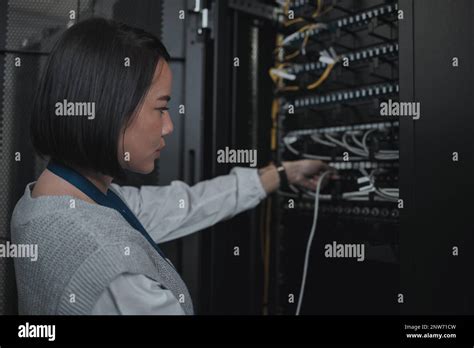 Asian Woman Technician And Server Room For Cabling Networking Or System Maintenance At Office