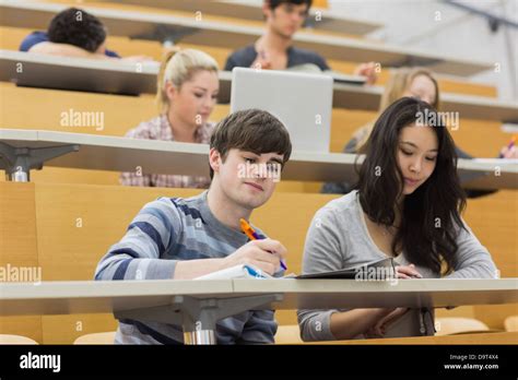 Babes Listening And Taking Notes In A Lecture Stock Photo Alamy