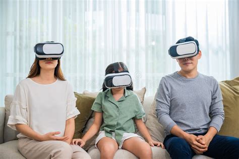 Asian Family Wear Vr Glasses Headsets Sitting On Sofa In Living Room Stock Image Image Of