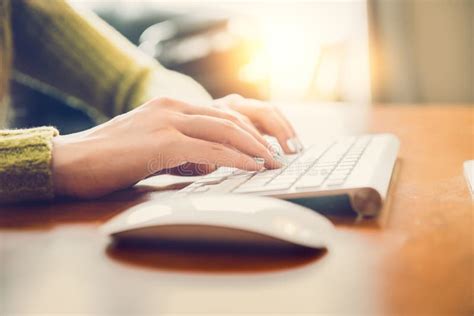 female hands typing text on a wireless keyboard woman working on