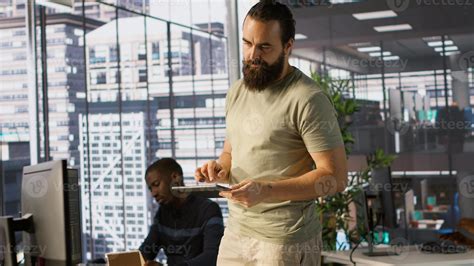 System Administrator Checking Results On Tablet After Creating Complex Machine Learning Models