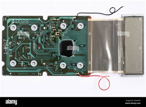 Electronic Circuit Board Of A Calculator With Many Electrical Components And A Red And Black