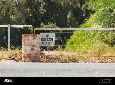 A Sign Reads UN Buffer Zone Keep Out At A Border Crossing Between The Northern And Southern