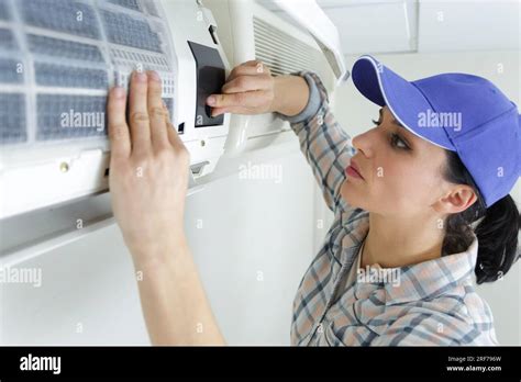 Female Technician Working On Air Conditioning Unit Stock Photo Alamy