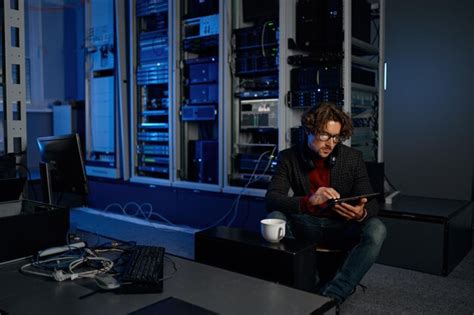 Premium Photo Male IT Technician Working In Server Room With Tablet Man Engineer Near Racks