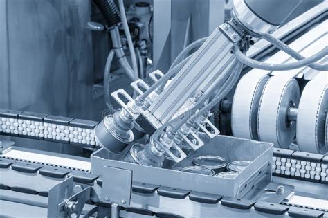 The High Technology Material Handling Process In Canned Food Production By Robotic System Stock