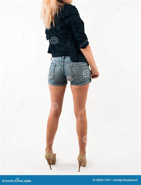 Audacious And Fashionable Slim Young Woman Poses In Distressed Denim