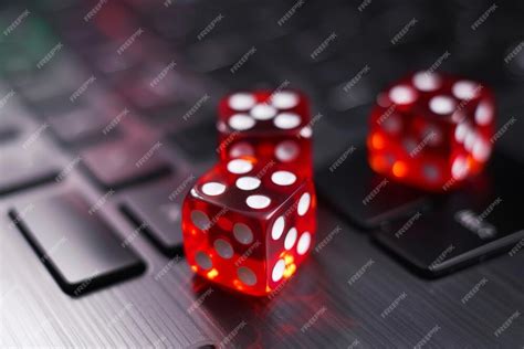 Translucent Red Dice On A Laptop Keyboard Emitting A Radiant Backlight