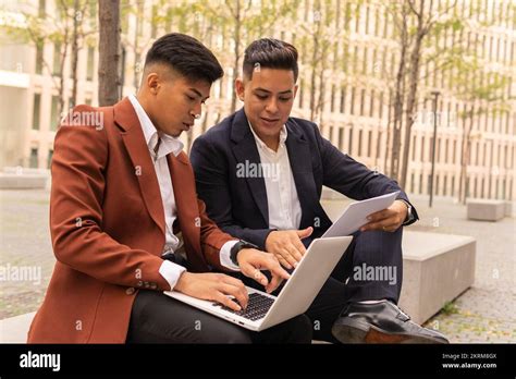 Focused Hispanic Businessmen In Classy Outfits With Documentation Using