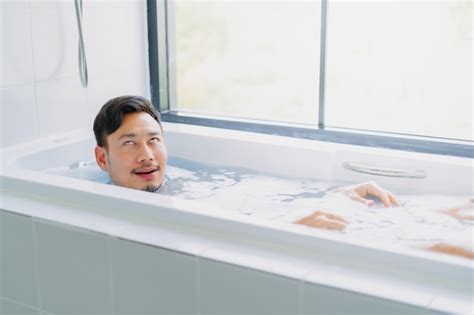 Premium Photo Funny Asian Man Play And Pose In The Bathtub Bathroom