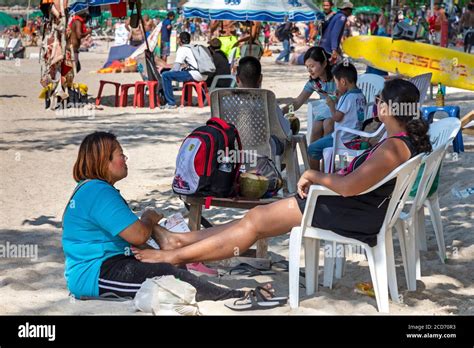 Tourist Having A Massage On The Beach At Patong Phuket Thailand Stock