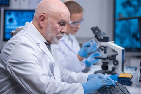 Professor And His Young And Professional Laboratory Assistant Are Doing