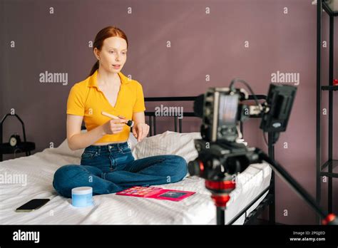 Redhead Female Beauty Blogger Applying Skin Powder With Brush Filming Daily Makeup Routine