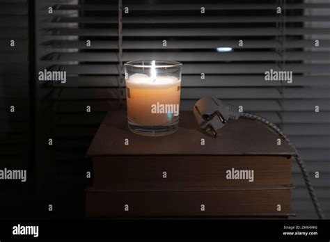 A Disconnected Electric Plug Lies In A Dark Empty Room Near The Window
