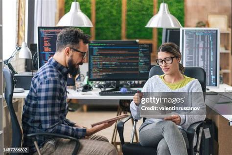 Software Programmers Analyzing Html Code And Database Brainstorming Software Programmers Analyzing Html Code And Database Brainstorming