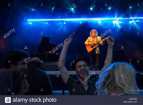 Spectators Sing Along With Canadian Singer Ben Caplan Singing And Playing The Guitar On Stage