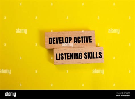 Develop Active Listening Skills Message Written On Wooden Blocks With Yellow Background