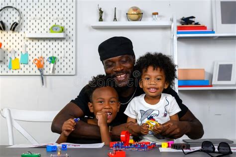 Loving Father Teaches And Plays With Son At Home For Learning And Education On Electric Circuit