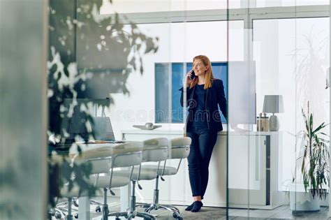 Businesswoman Talking On Smartphone In Modern Office Setting Stock Image Image Of