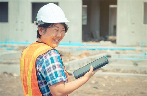 Asian Women Engineering Holds A Tablet For Use In The Inspection Of