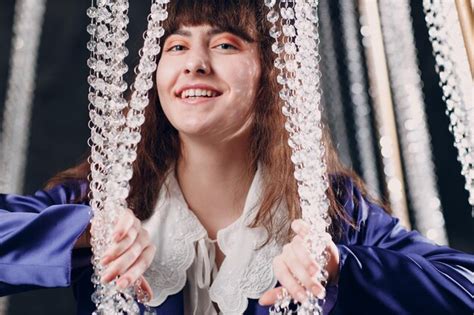 Premium Photo Portrait Of Young Woman Sitting On Hammock