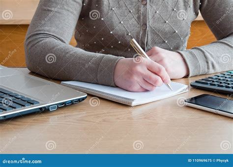 A Woman Conducts Accounting Calculations In The Office Stock Image